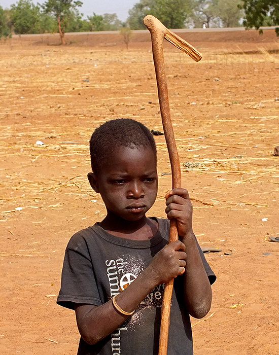 Life in African villages. Even the youngest have work to do. - Lighting ...